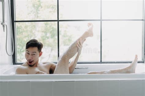 Funny Man Lying In The Bathtub Showing His Leg Pretend To Be A Woman