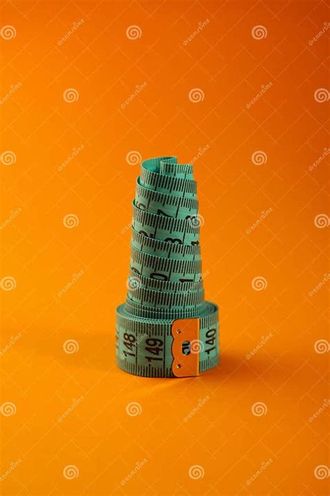 on a bright orange background a blue sewing centimeter and a juicy