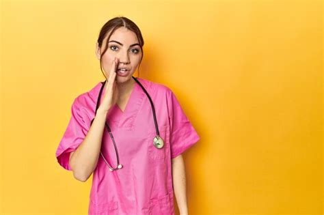 Premium Photo Nursing Assistant In Yellow Background Is Saying A Secret Hot Braking News And