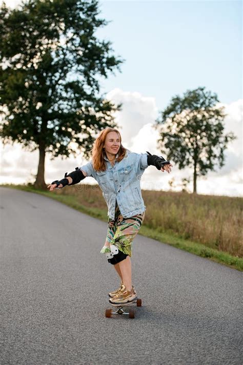 Country Road Laughter Young Beautiful Girl Rides A Longboard Stock