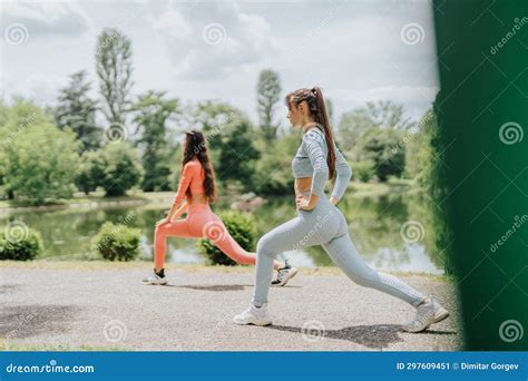 Two Fit Women Demonstrate Stretch Exercises In An Urban Park