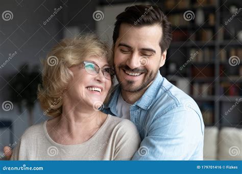 Aged Mother And Grownup Son Embracing Laughing Enjoy Time Together