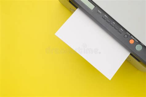 Top View Of The Printer And A Blank Sheet Of A4 Paper On A Yellow
