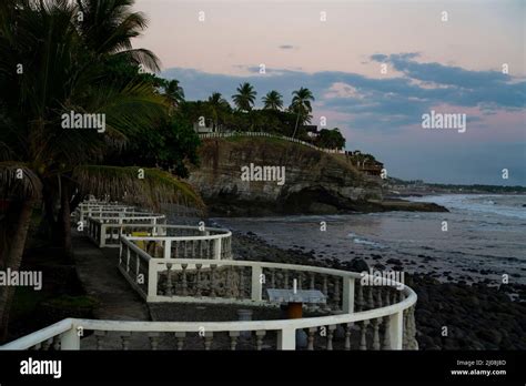 View Of Natural Rocky Beach And Cliff With Palm Trees In El Tunco El