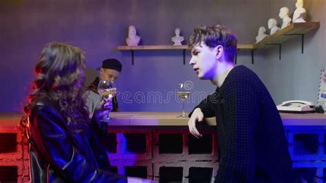 A Young Couple Meets In A Nightclub Bar A Guy Swears With A Girl The