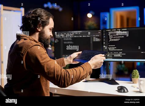 Angry Programmer Trying To Smash Keyboard In Frustration After Failing To Secure Company Servers