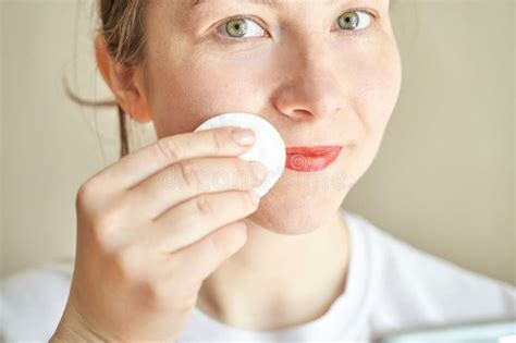 Woman Cleansing Face With Cotton Pad And Remover For Daily Skincare