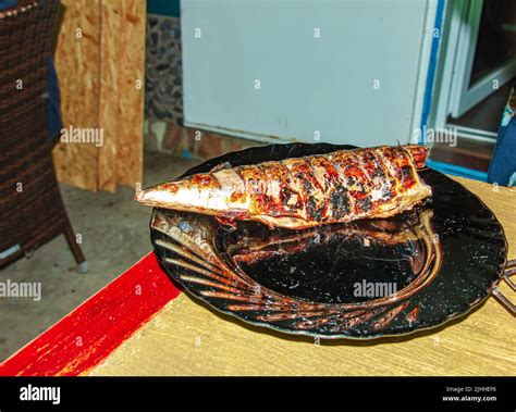 The Process Of Cooking Mackerel Fish In A Marinade On The Grill Fried