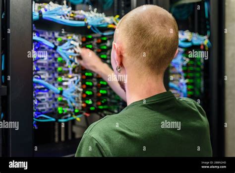 man data center technician performing server maintenance replacing