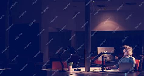 Premium Photo Young Man Working On Computer At Night In Dark Office The Designer Works In The