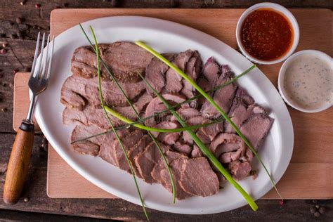 Different Types Of Cooked Meat With Hot Sauces On Wooden Table Stock Photo Image Of Pepper