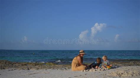 Young Mom Spending Quality Time With Her Two Sons On A Beautiful