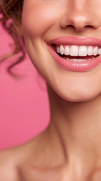 A Closeup Of A Woman Flaunting Her Sparkling Clean Teeth With A Smile Set Against A Pink