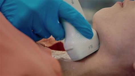 Thyroid Ultrasound Procedure On Patient At Hospital Woman Reclined On