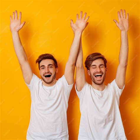 Two Men With Their Arms Up In The Air One Of Them Is Wearing A White