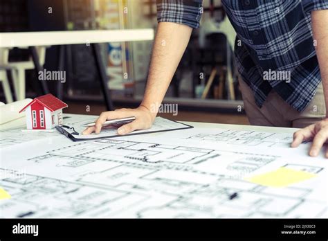 Engineers Are Designing Working On Blueprints And Analyzing The Structure Of The Project Stock