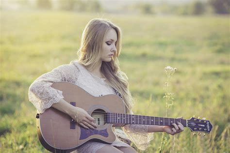 Woman Playing Brown Wooden Acoustic Guitar During Daytime · Free Stock