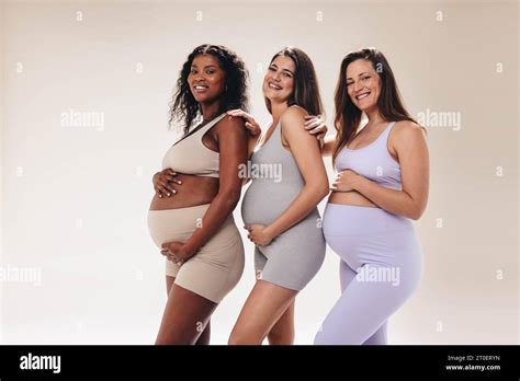 Pregnant Women Enjoying A Diverse Prenatal Yoga Class Bonding Over Their Shared Journey Into