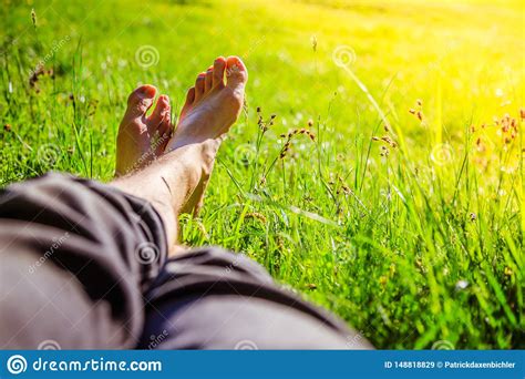 Chilling In The Green Grass Legs Of A Young Man Relaxing Summertime