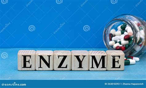 Enzyme Word On Cubes On A Blue Background With A Jar Of Tablets Stock