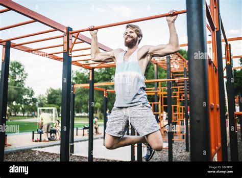 Strong Athlete Doing Pull Up On Horizontal Bar Muscular Man Doing Pull