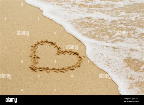 Drawing Of A Heart Shape On The Sand And Wave With Foam Stock Photo Alamy