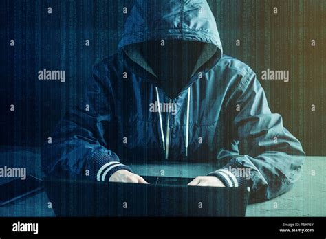 Anonymous Hacker Programmer Uses A Laptop To Hack The System Stealing