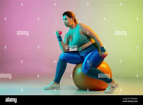 Young Caucasian Plus Size Female Models Training On Gradient Purple