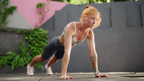 Fit Redhead Woman Performs Push Ups In Outdoor Tropical Gym Strength Endurance Muscular