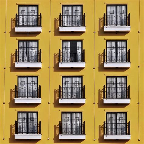 Architectural Photography Of Three Pink Blue And Yellow Buildings