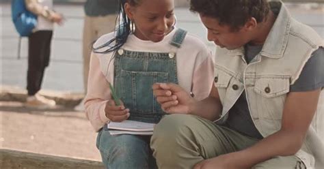 School Classmates Working In Pair At Outdoor Lesson By