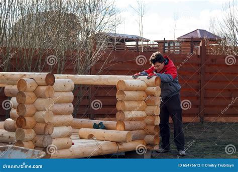 Man Builds Structure Made Of Logs Royalty Free Stock Image