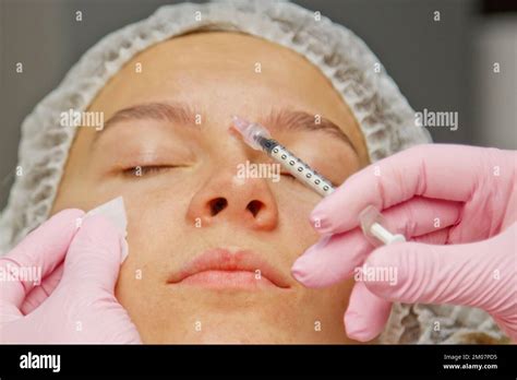 Contour Plastic A Cosmetologist Injects A Botulinum Toxin To Tighten
