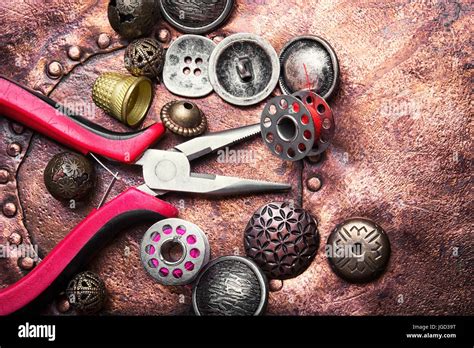 Metal Sewing Button And Thread Coil On Copper Retro Background Stock
