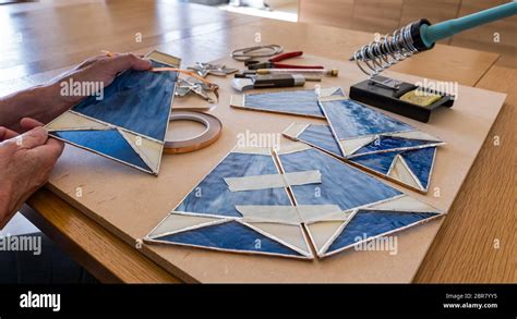 Woman Working On Hobby Craft Stained Glass Panels For Lamp Shade With