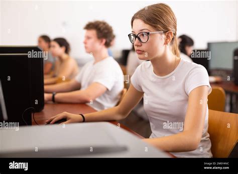 Portrait Of Interested Teen Girl During Lesson In Computer Room Of