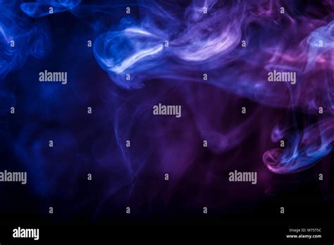 Dense Multicolored Smoke Of Blue And Pink Colors On A Black Isolated