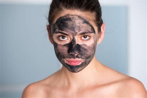 Premium Photo Facial Treatment Beautiful Young Woman With Charcoal