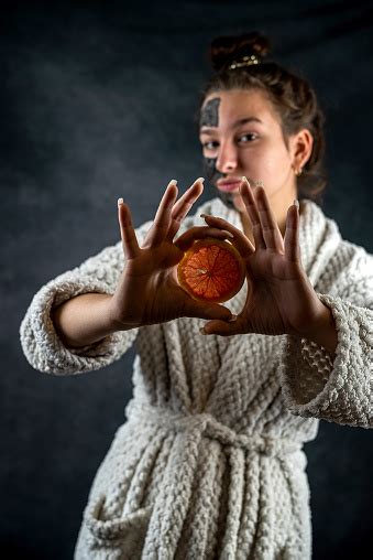 격리된 자몽을 들고 검은 얼굴 마스크를 쓴 흰색 목욕 가운을 입은 아름다운 소녀 20 24세에 대한 스톡 사진 및 기타 이미지 20 24세 20 29세 건강한 생활