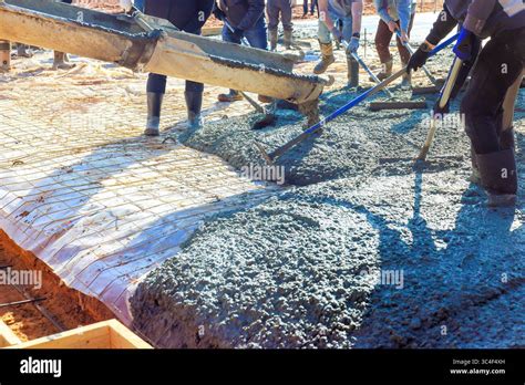 Laborers Are Pouring Concrete At Construction Site On Laying To