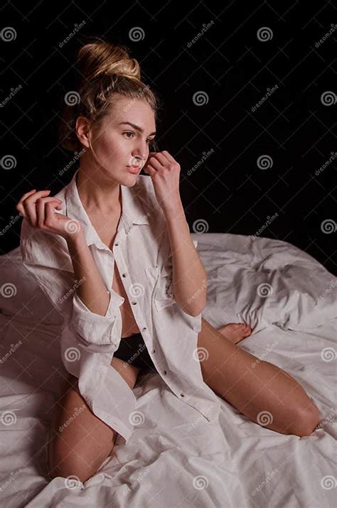 Beautiful Young Woman With Blonde Hair In A White Shirt On Naked Body