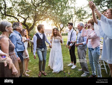 Bride Groom And Guests At Wedding Reception Outside In The Backyard