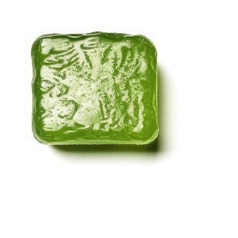Premium Photo A Green Square Shaped Piece Of Candy Is Placed On A