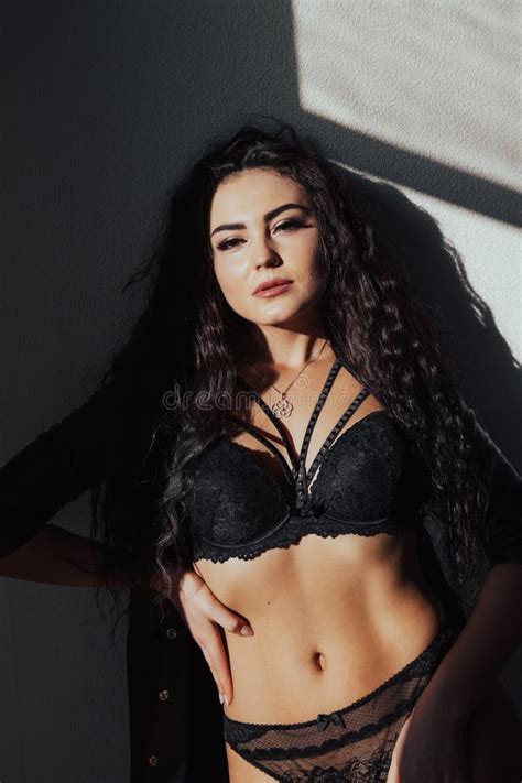 Portrait Of A Beautiful Brunette Woman In Black Lingerie Posing Stock