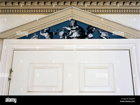 Close Up Of Small Classical Mural Within Pediment Between Carved