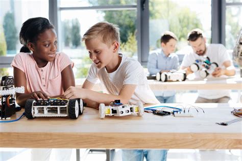 menino e menina que discutem a construção de um carro robótico imagem