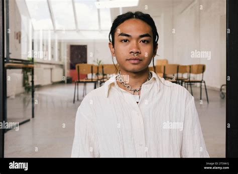 Portrait Of Non Binary Business Professional With Nose Ring At Office