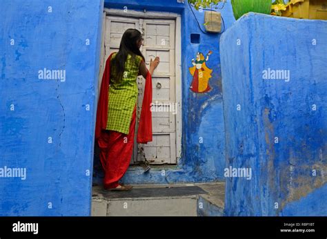 Woman Knocking Door Of Blue House Jodhpur Rajasthan India Asia