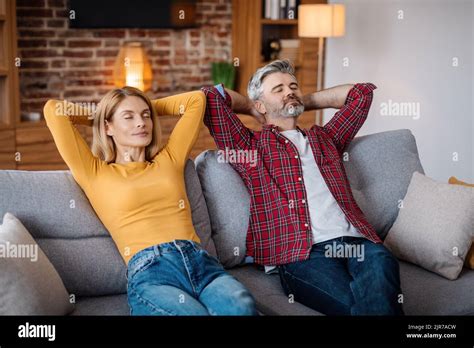 Happy Calm Middle Aged Caucasian Husband And Wife Resting With Eyes