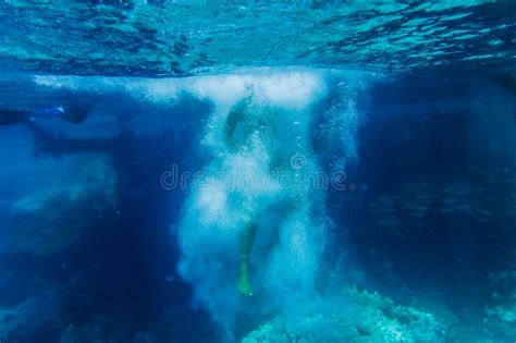 Woman In Bikini Jump Into The Clear Blue Water With Lot Of Bubbles On Vacation In Egypt Stock